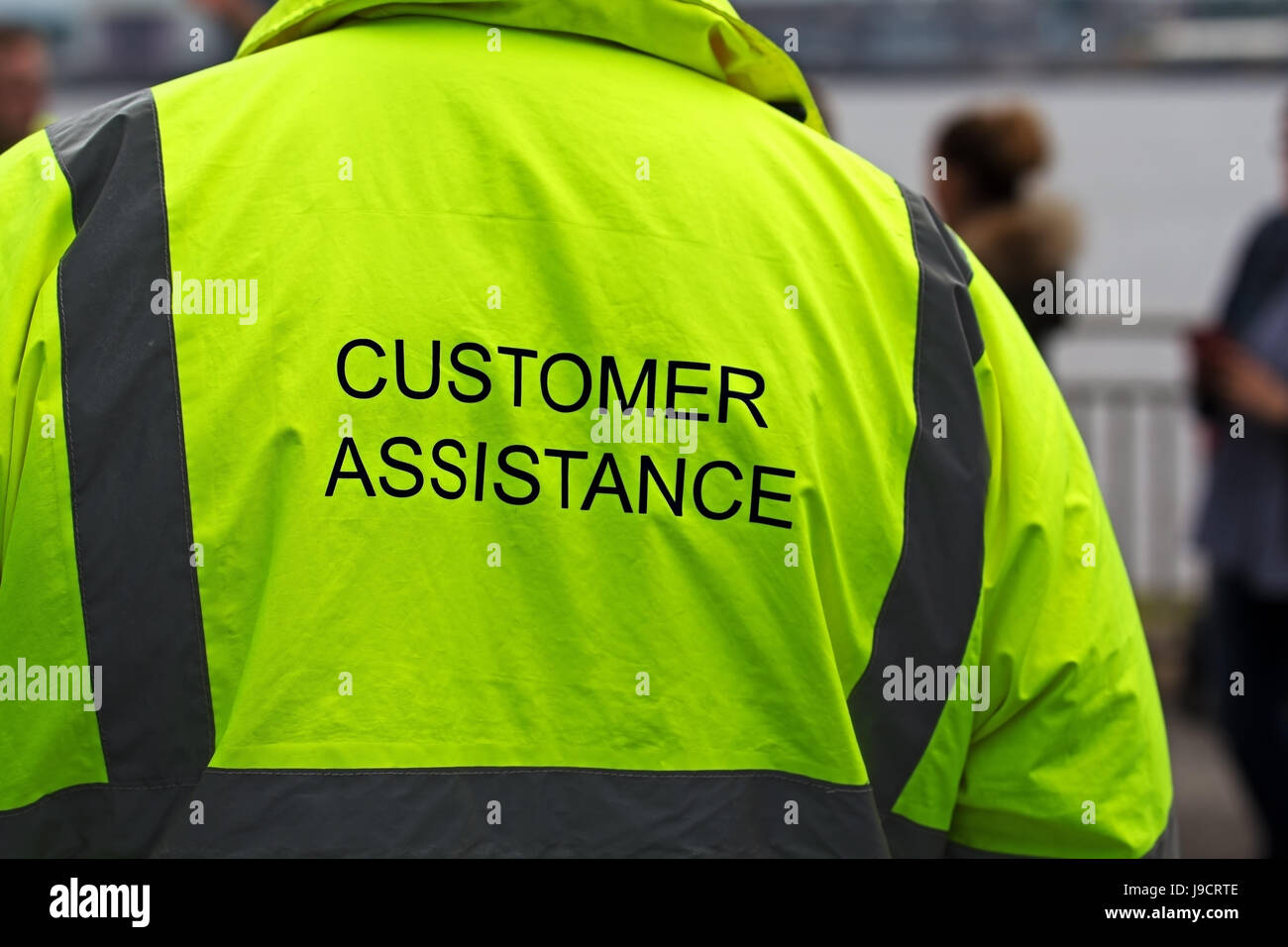 Man in hi-viz customer assistance jacket at an outdoor event Stock ...