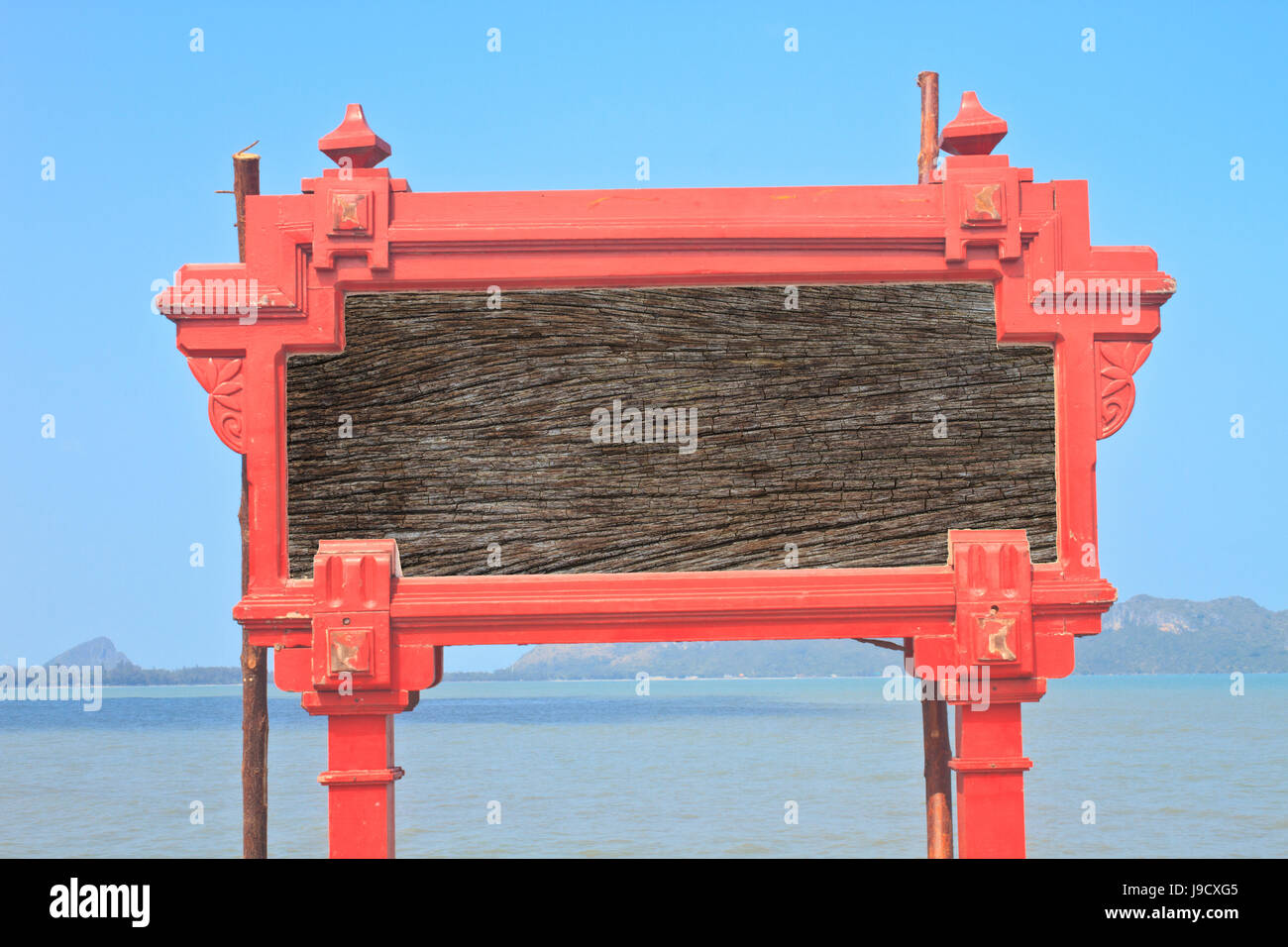 an image of a signpost situated against a wall at a sunny beach Stock ...