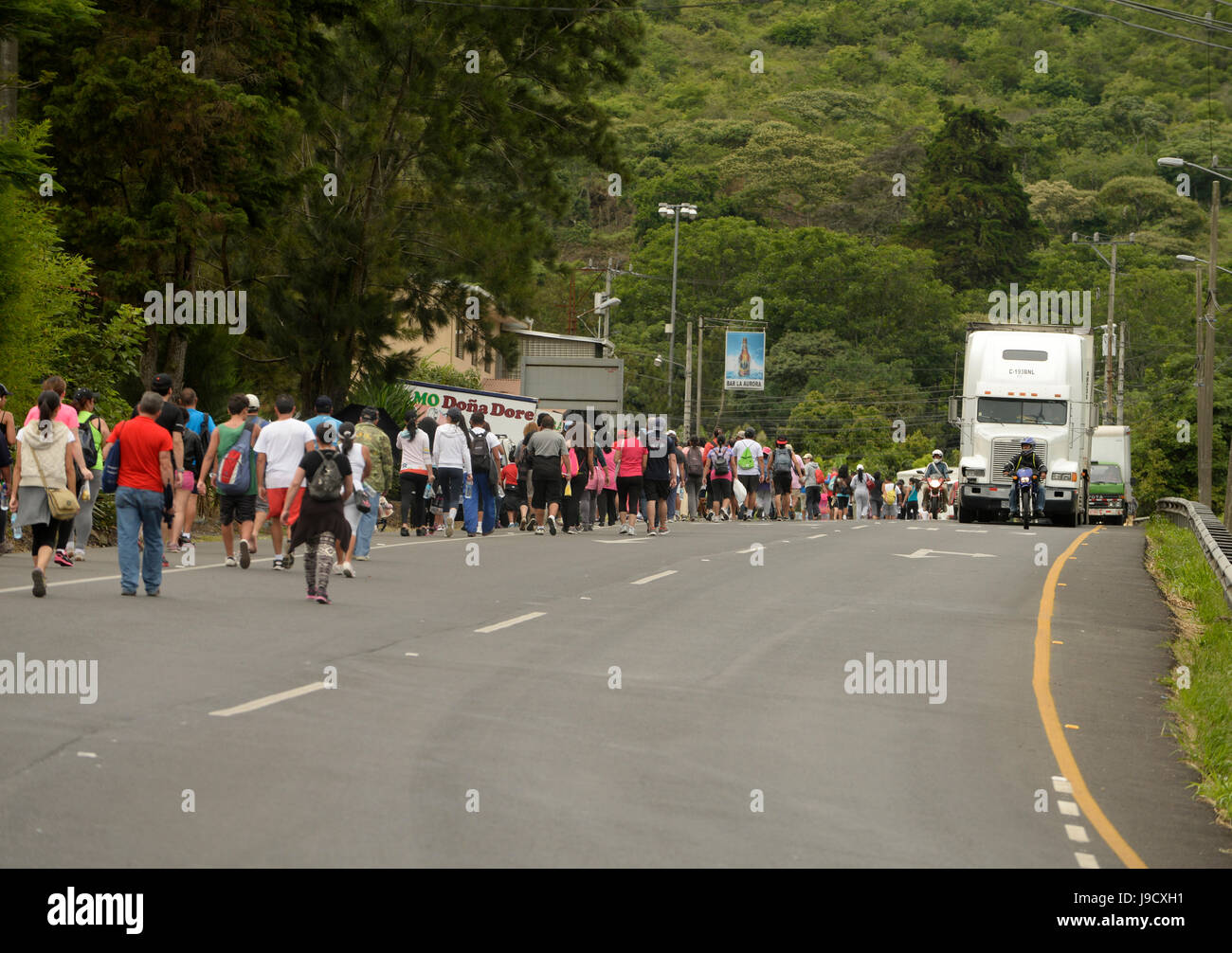 Pilgrims walk along the highway during the annual catholic pilgrimage ...