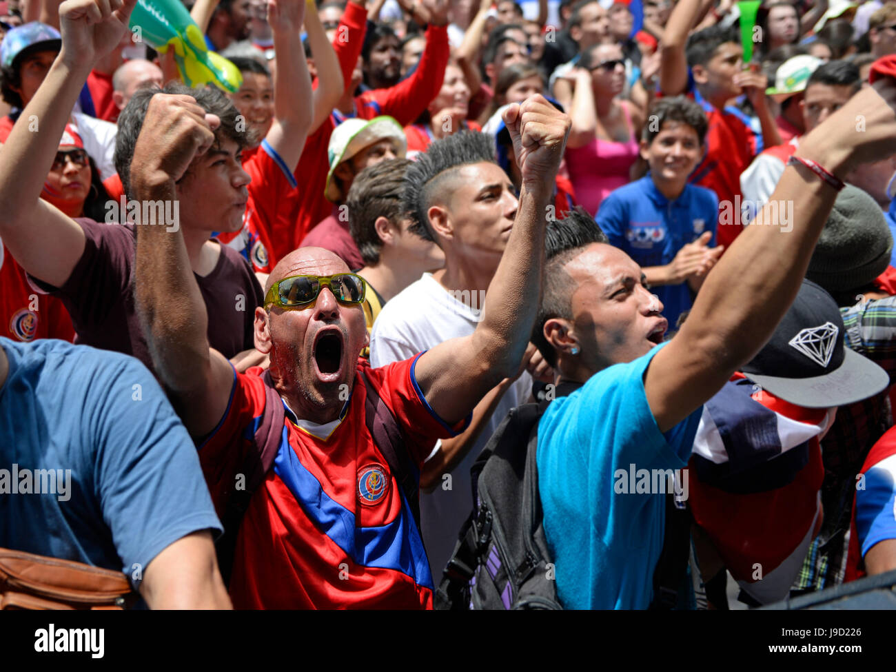 A Costa Rica fan waves his hands and chants while watching in San Jose ...
