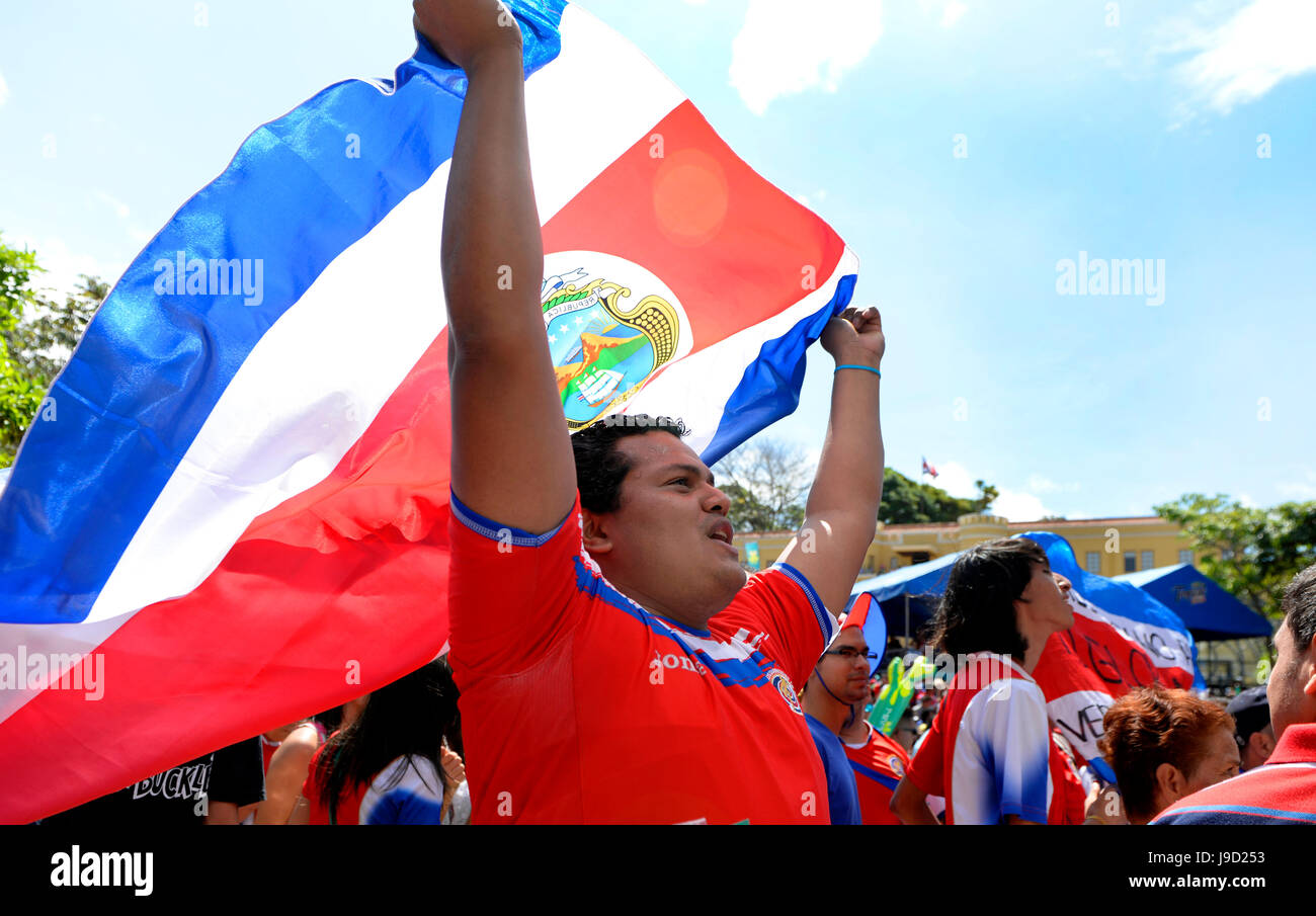 A Costa Rica fan waves the Costa Rican flag as the Costa Rican national ...