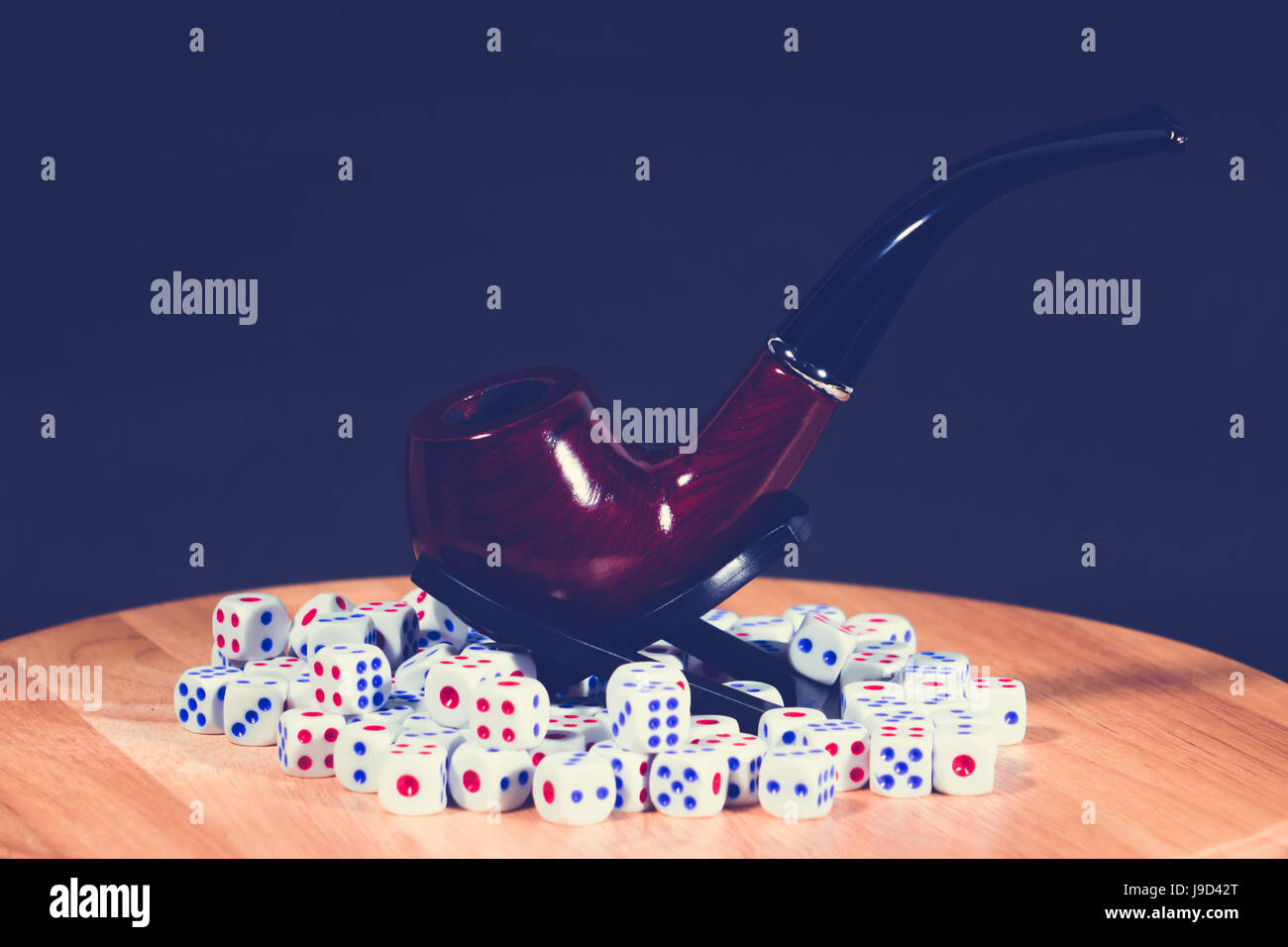 Smoking Tobacco Pipe with many dice Stock Photo - Alamy