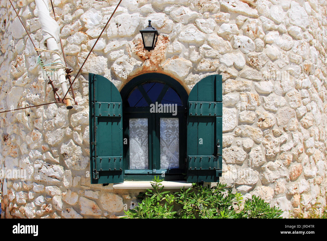 Old window in stone wall at traditional windmill on Greece Stock Photo ...