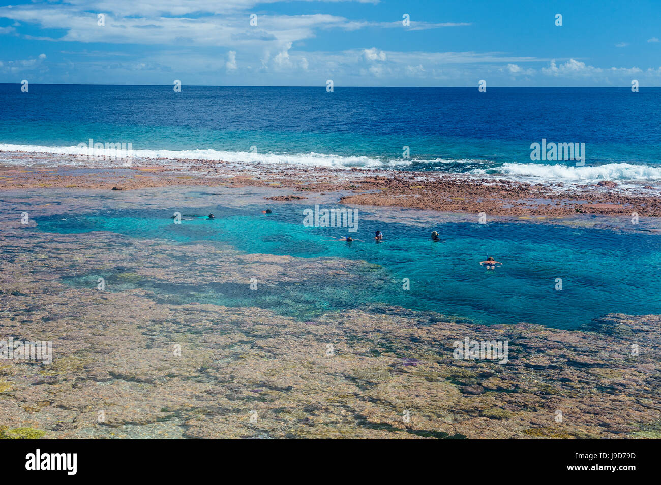 People swimming in the amazing Limu low tide pools, Niue, South Pacific ...