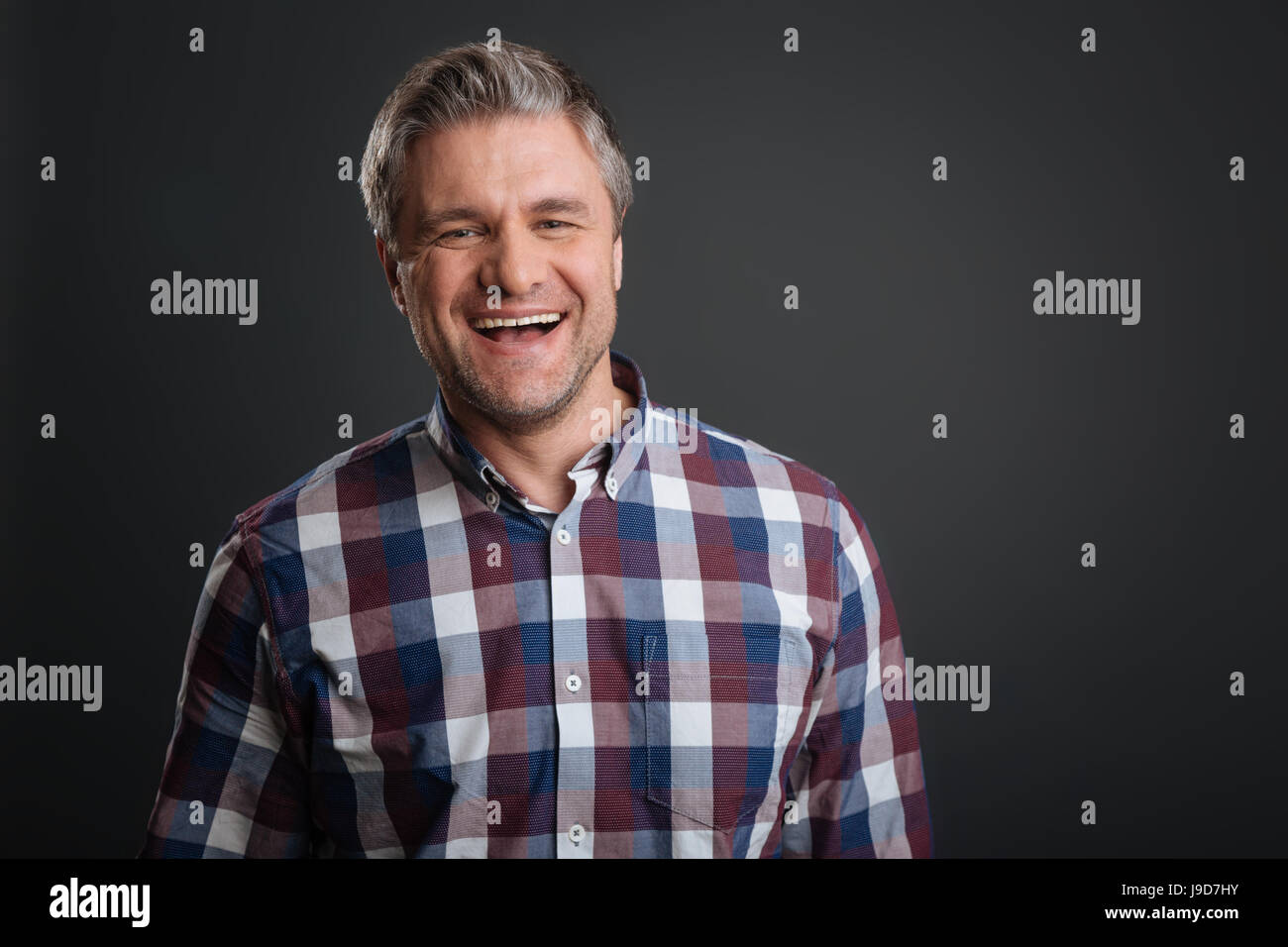 Good laugh. Radiant bright nice guy looking enthusiastic while laughing ...