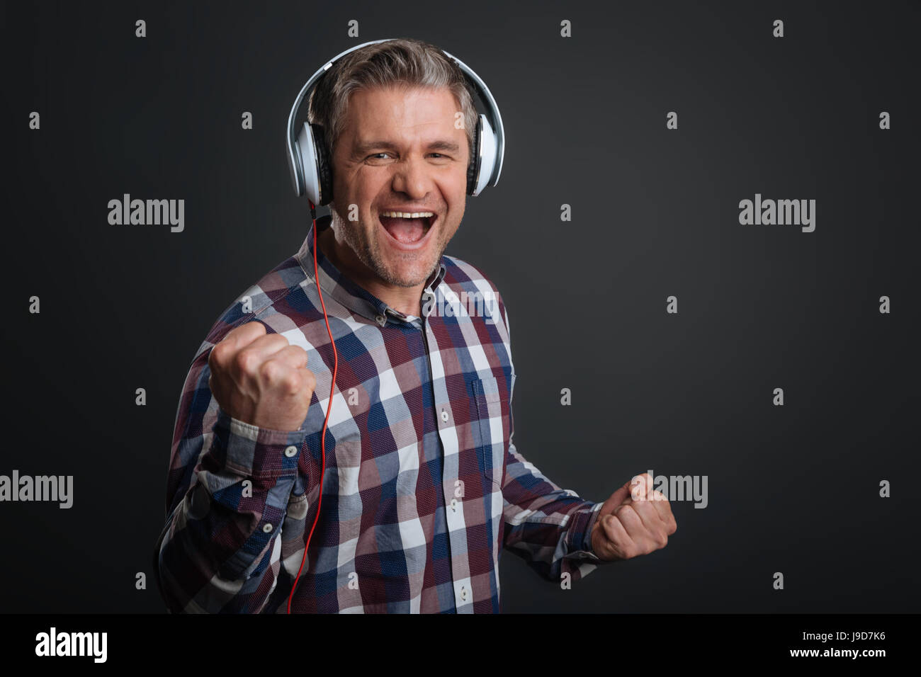 Power of music. Inspired active nice guy being very emotional while ...