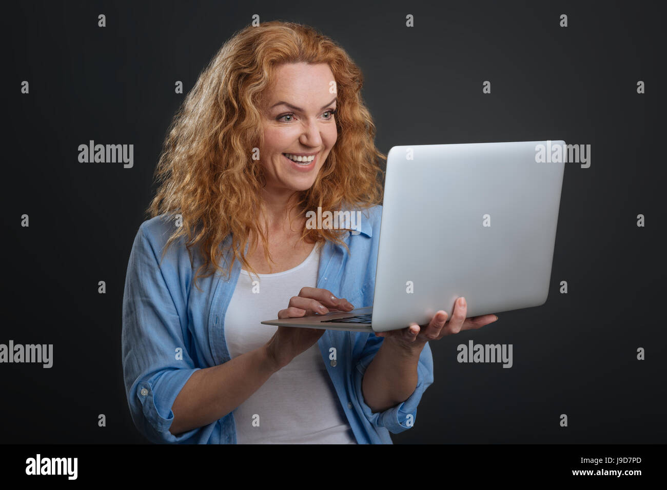 Electronic communication. Inspired cute motivated lady using her laptop ...