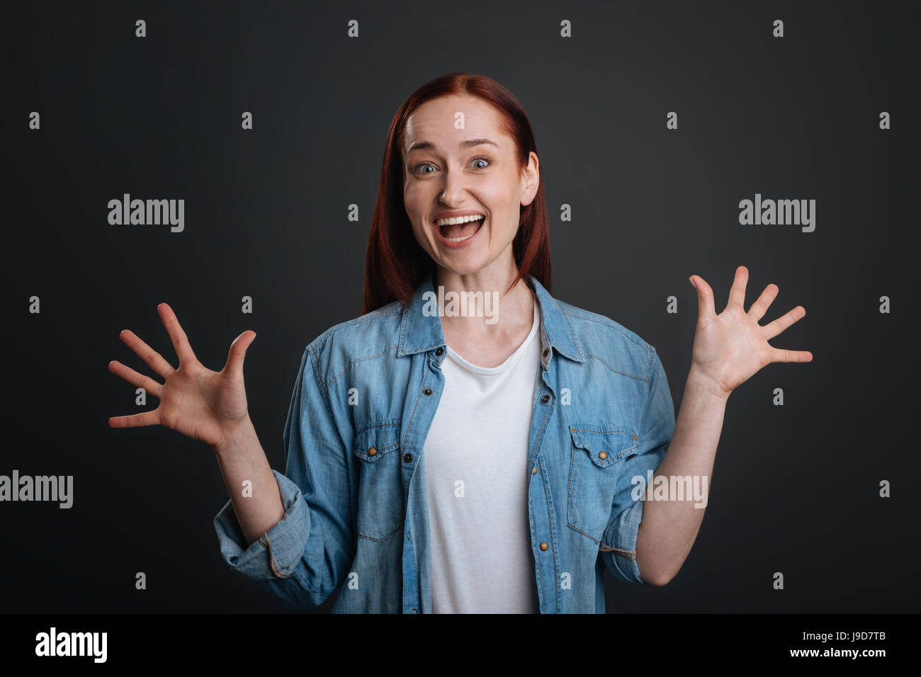 Woman throwing hands indoors hi-res stock photography and images - Alamy