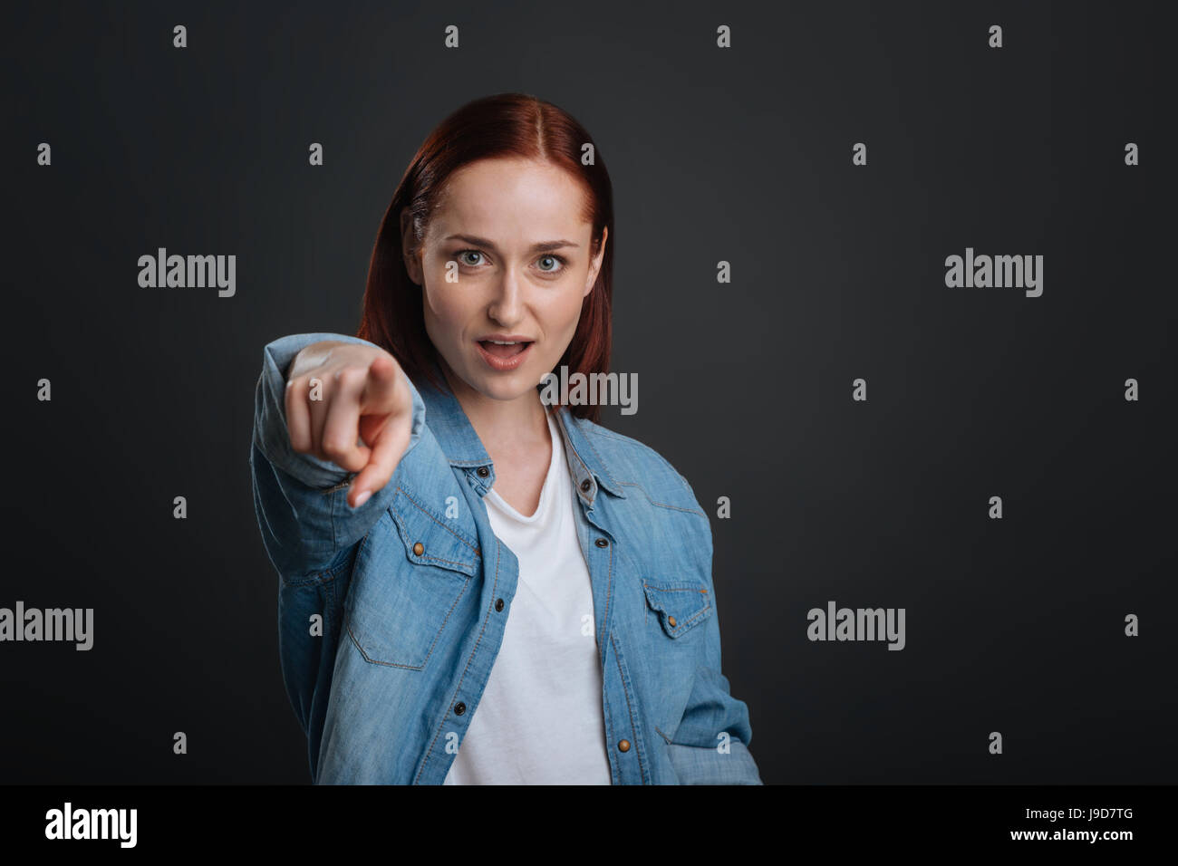 Smiling woman pointing someone hi-res stock photography and images - Alamy