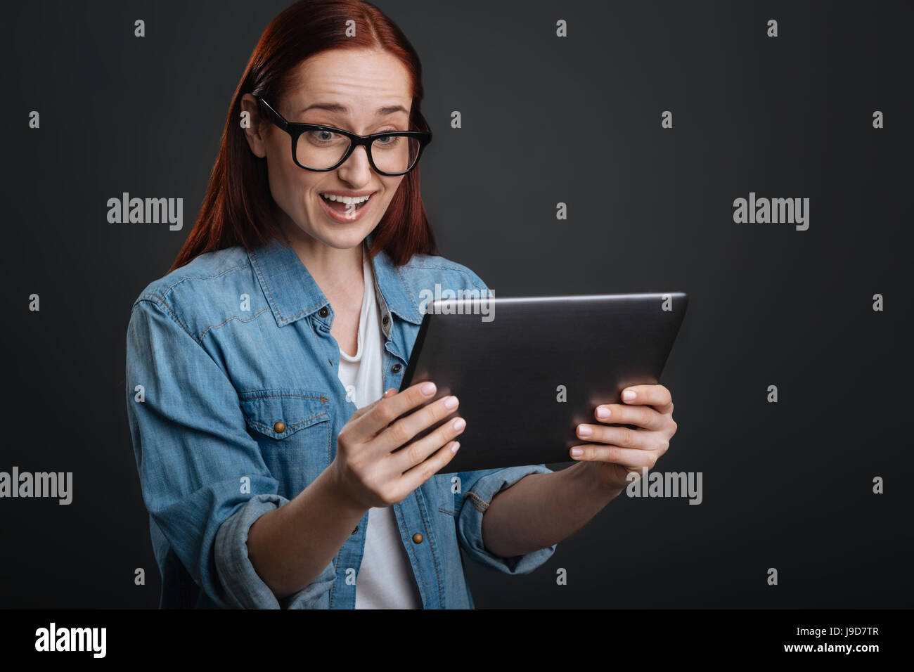 No way. Charming smart lively lady looking shocked while reading an ...