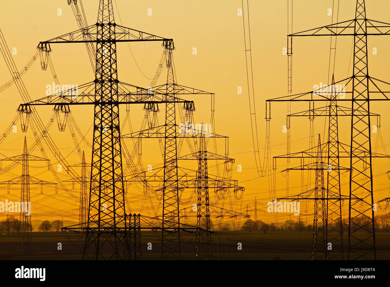 Pylons and power lines in morning light, Germany, Europe Stock Photo ...