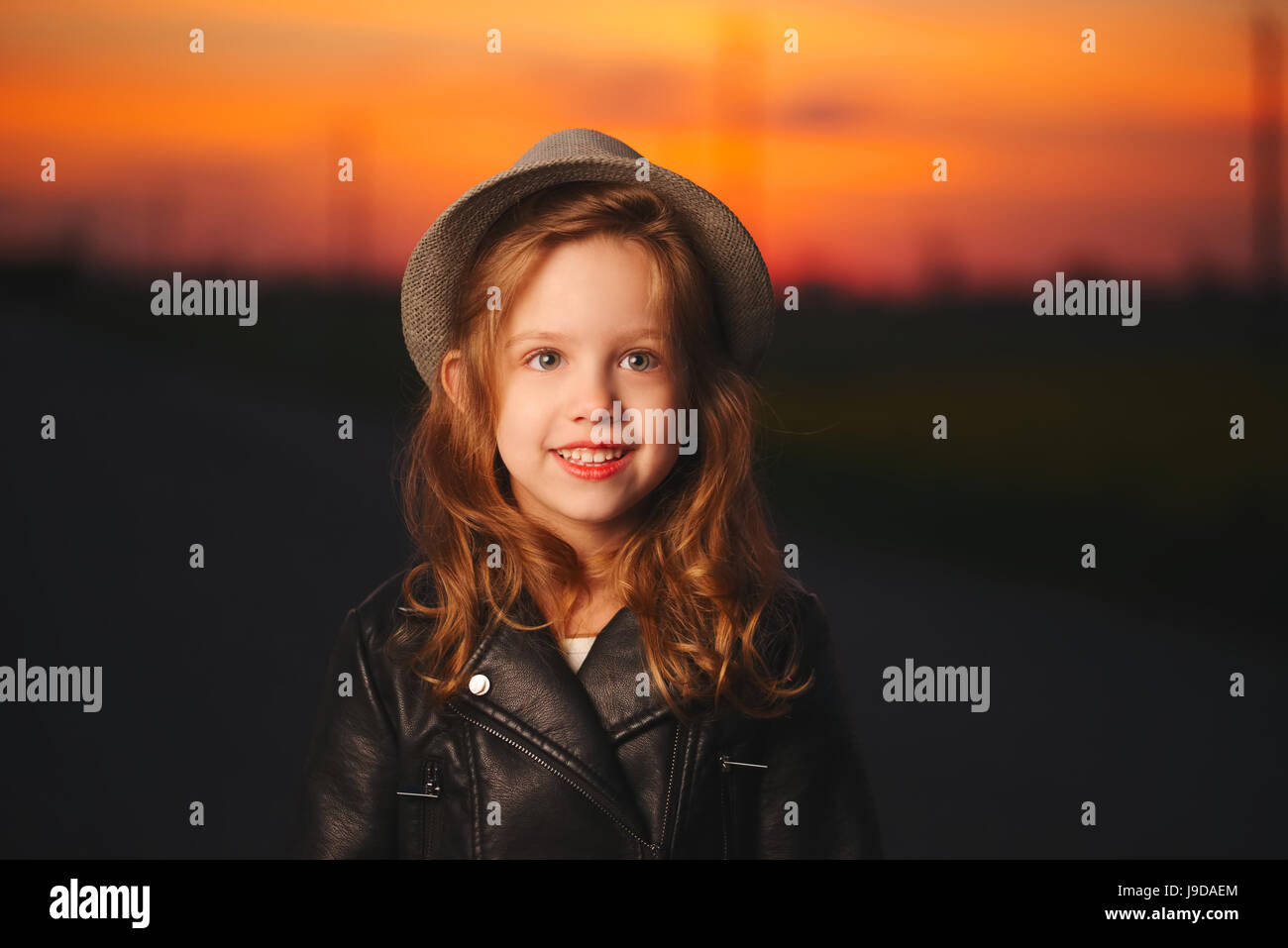 little girl with hat on evening sunset Stock Photo - Alamy
