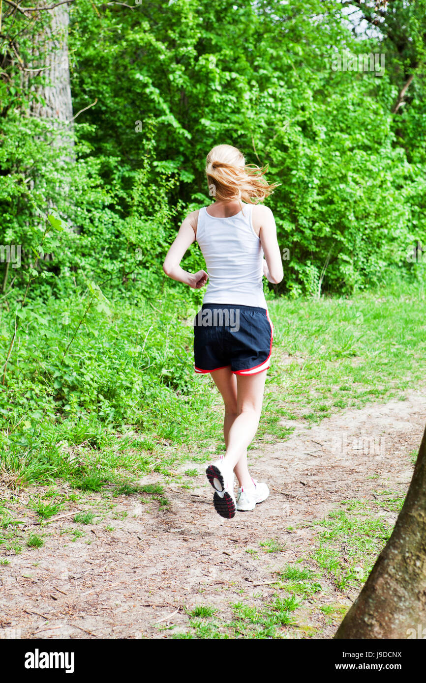 Woman goes in sports park hi-res stock photography and images - Alamy