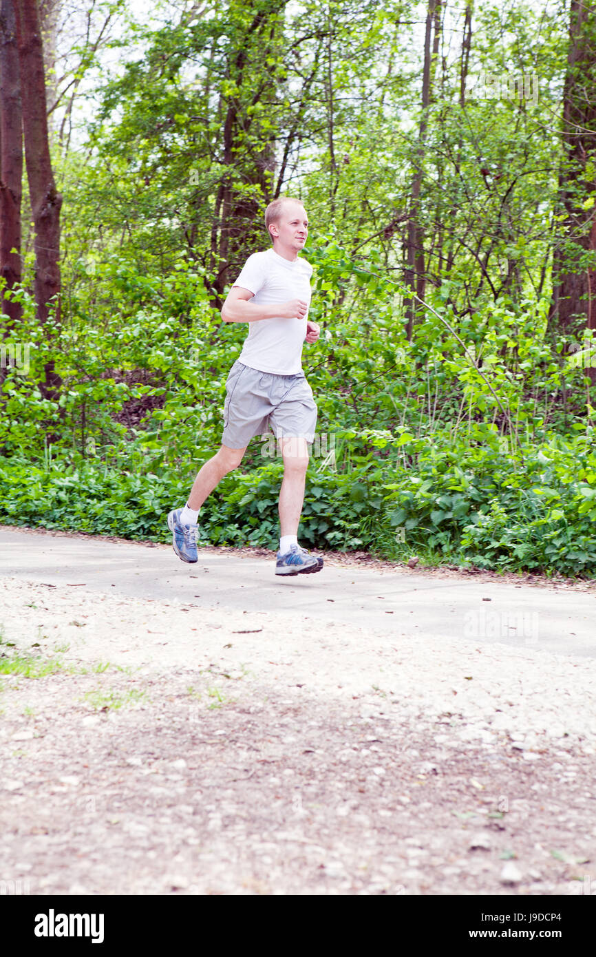 young man walking on a forest path jog Stock Photo - Alamy