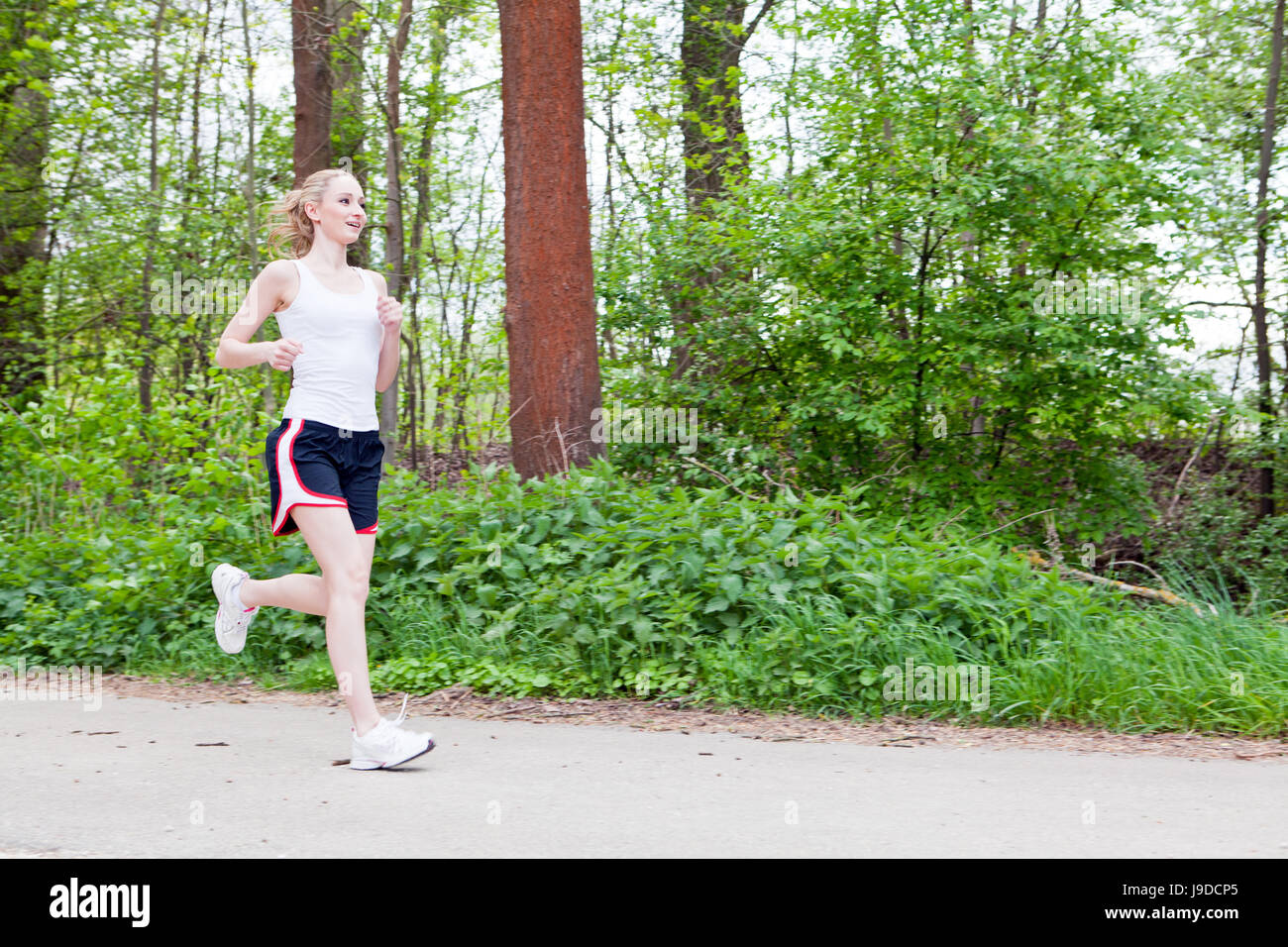 Woman goes in sports park hi-res stock photography and images - Alamy