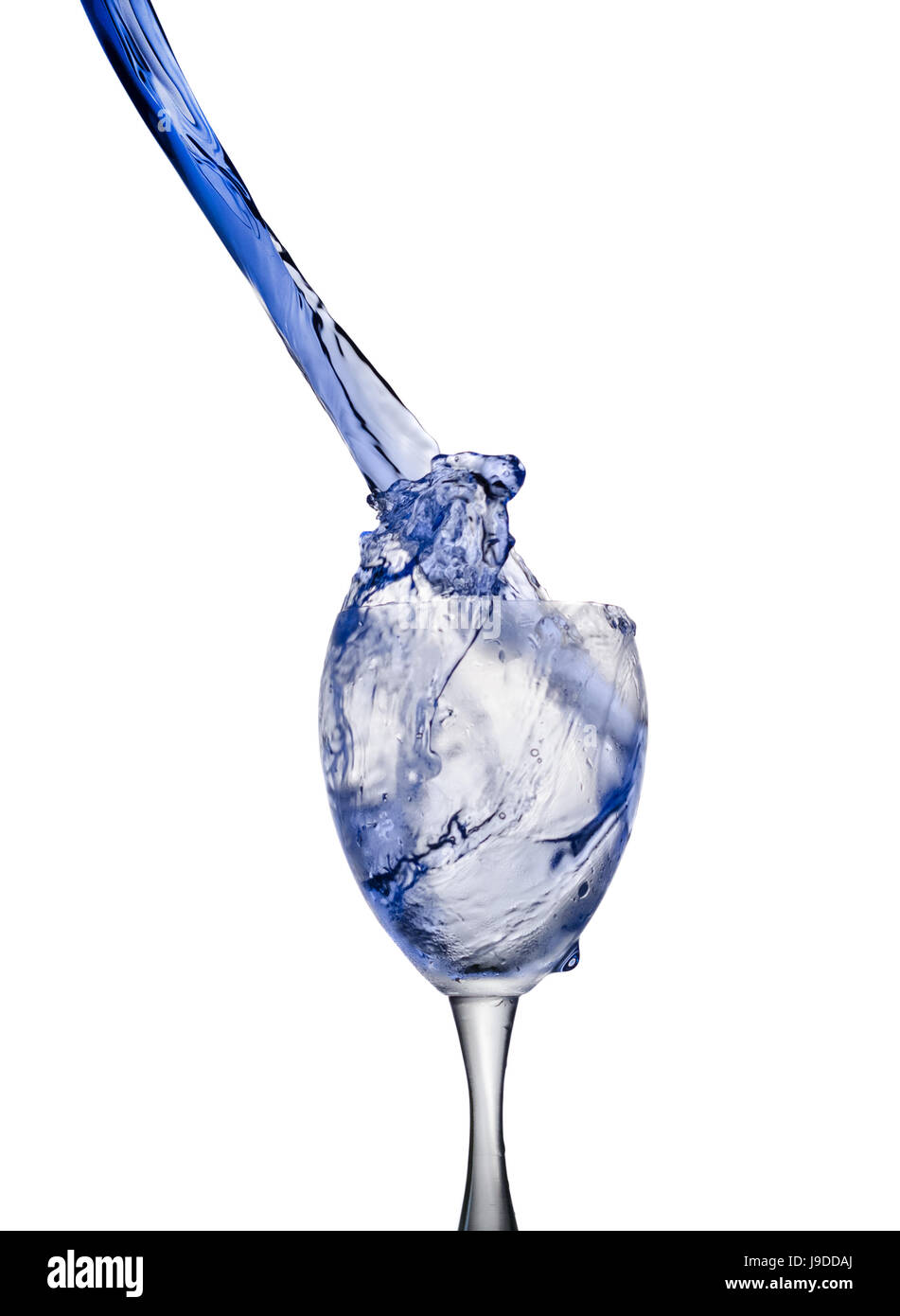 A stream of poured bright blue liquid splashes into a tilted clear wine ...