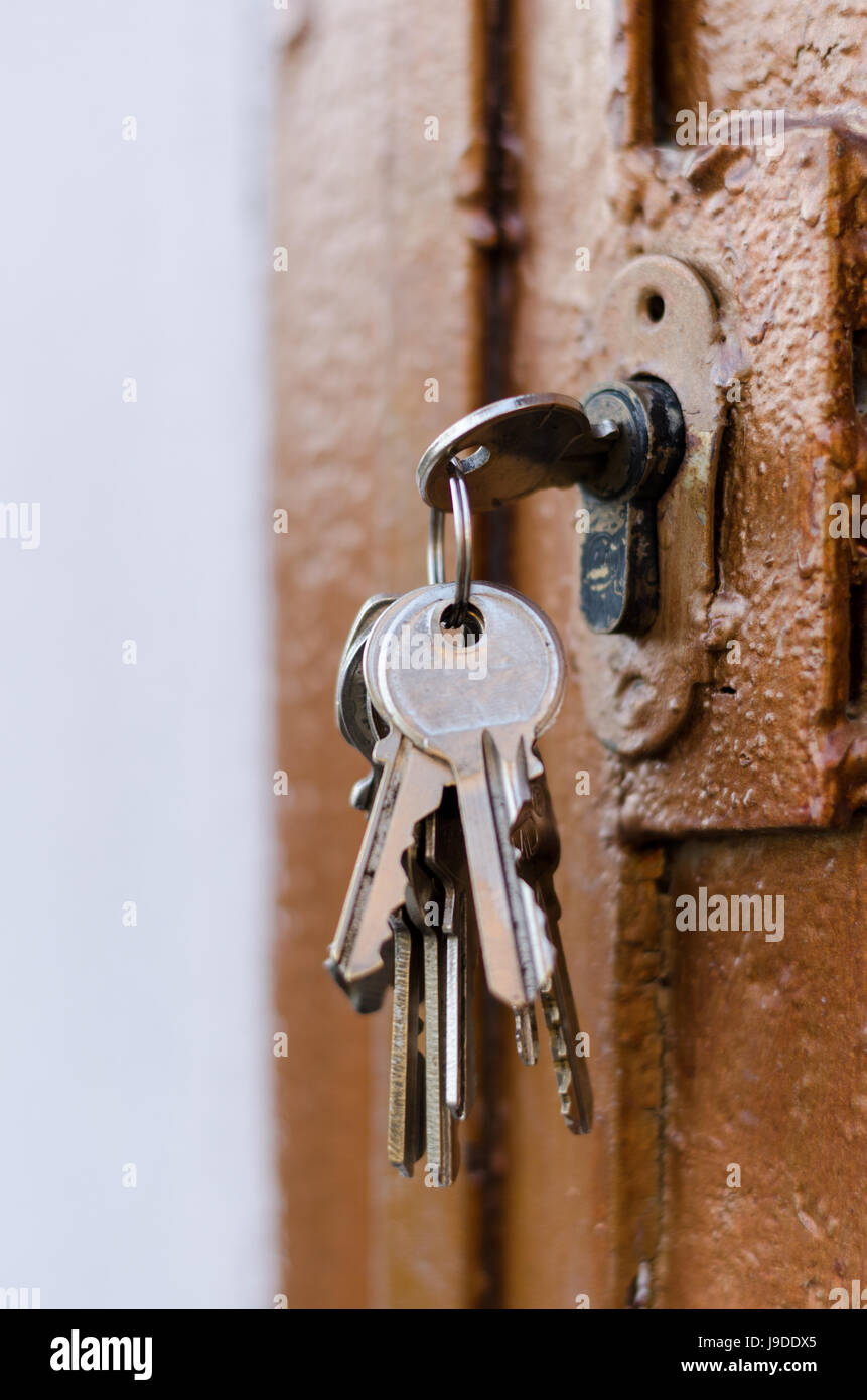 Key in keyhole on door Stock Photo - Alamy