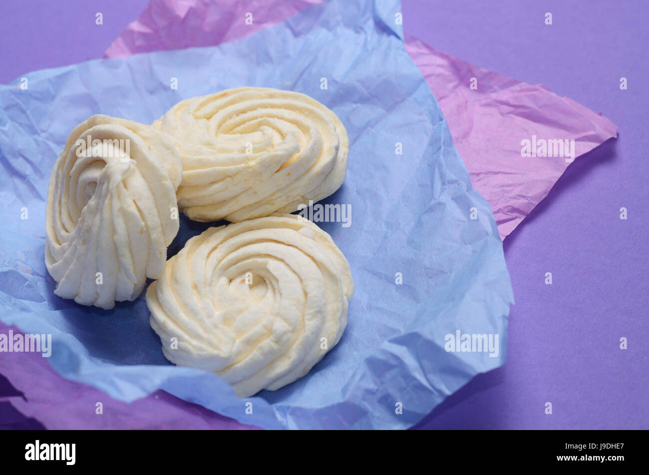 Food Photo of homemade zephyr, marshmallow in violet wrapping paper and ...