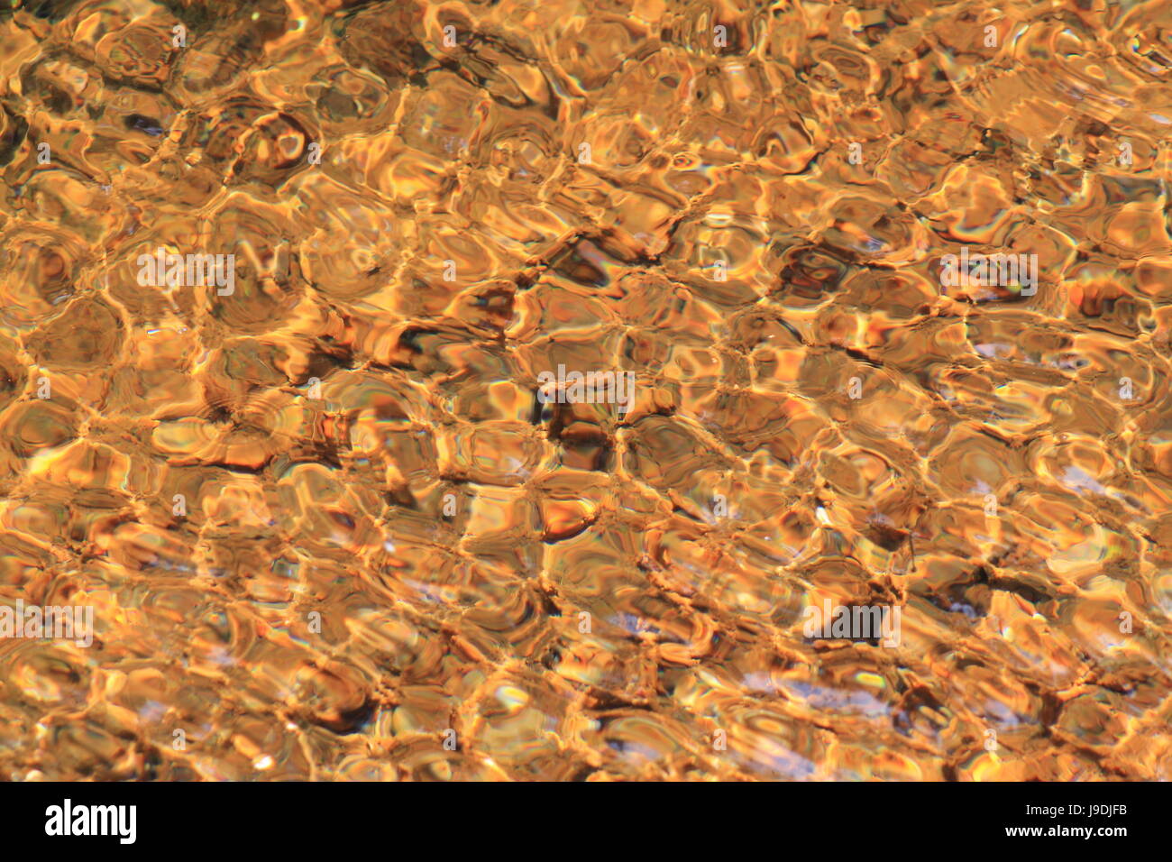ferruginous rocks in a mountain lake Stock Photo - Alamy