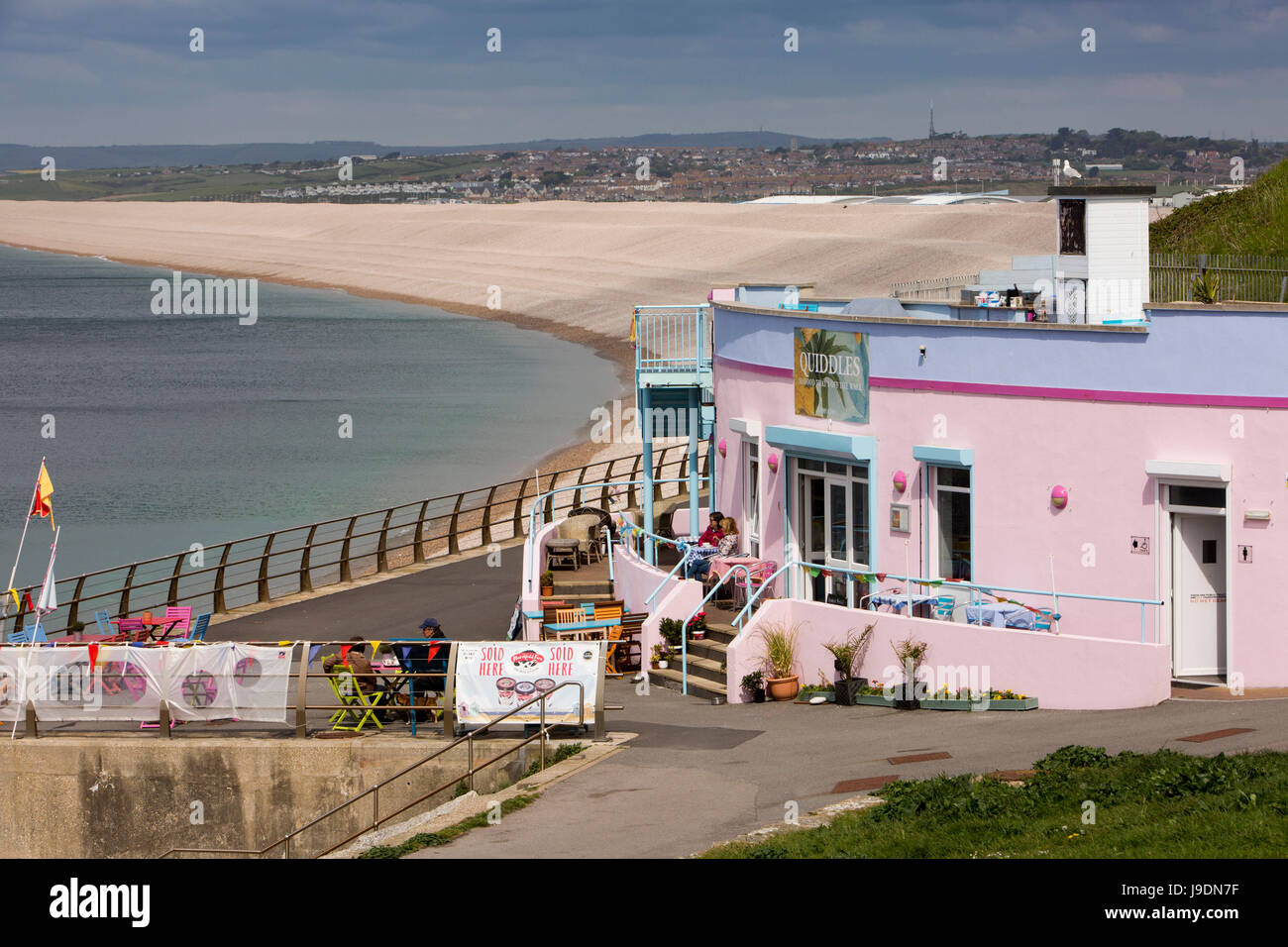 UK England, Dorset, Portland, Chiswell Cove, customers outside Quiddles ...