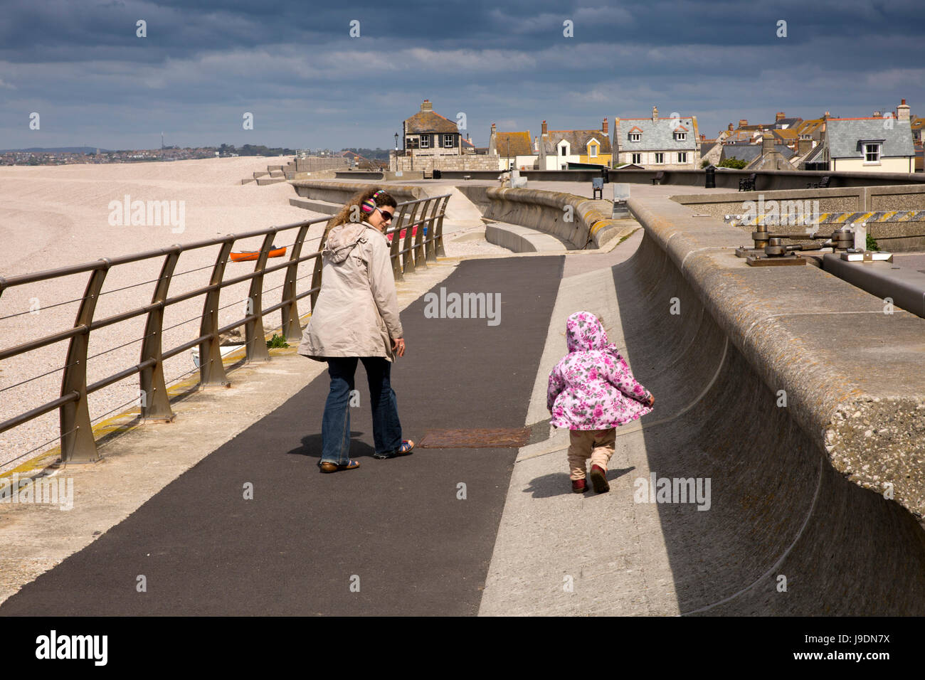 UK England, Dorset, Portland, Chiswell, mother and daughter on sea ...