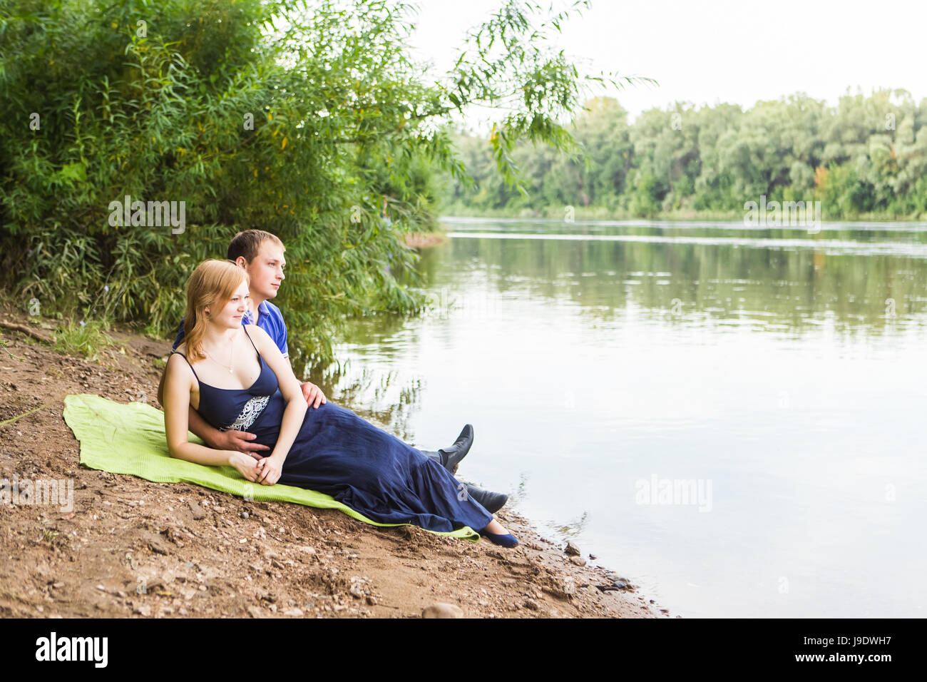 Romantic young couple in love relaxing outdoors in park Stock Photo - Alamy
