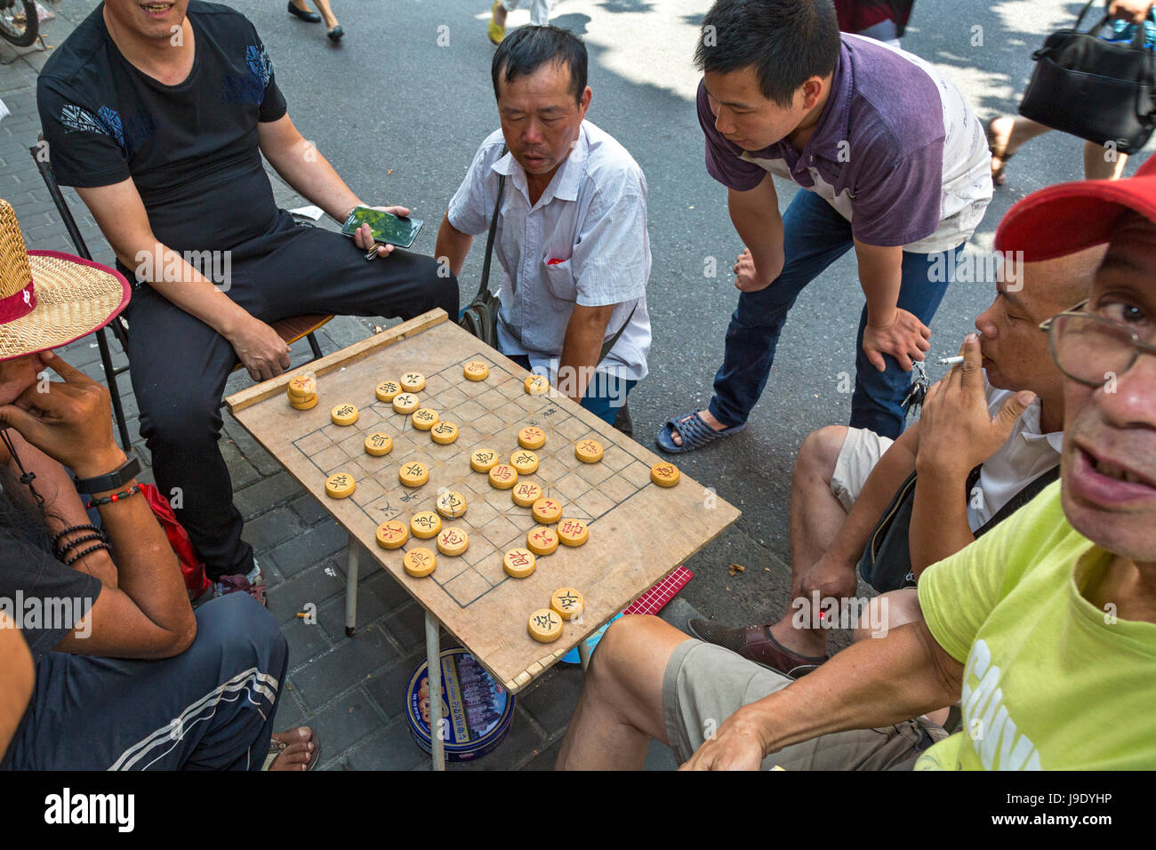 Chinese senior citizens playing board game in the street, Shanghai ...