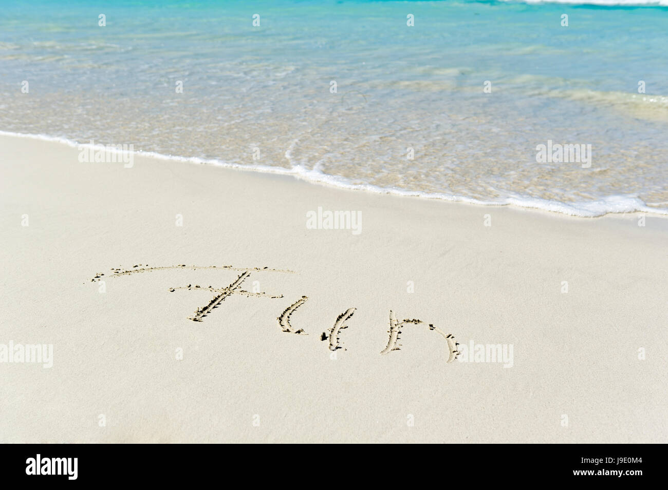 fun written in the sand Stock Photo - Alamy