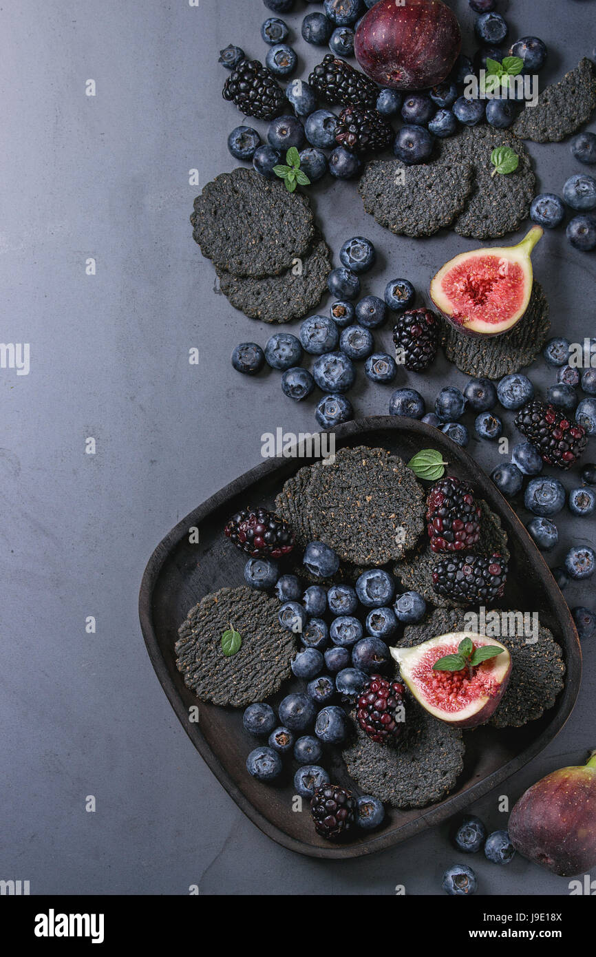 Variety of berries and figs with black crackers Stock Photo - Alamy