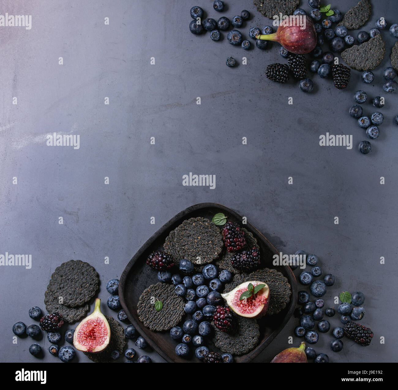 Variety of berries and figs with black crackers Stock Photo - Alamy