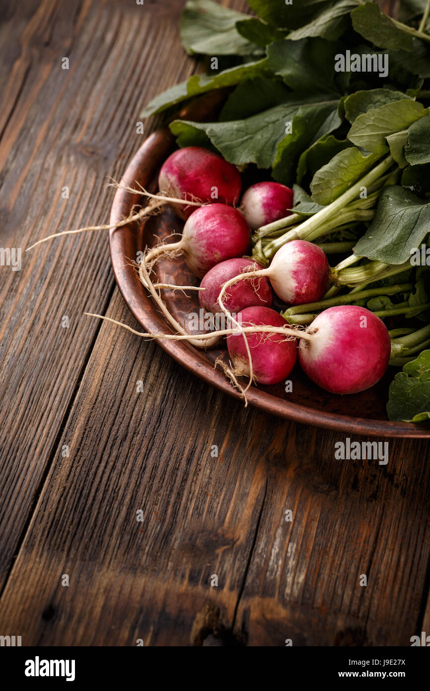 Small garden radishes on rustic style background Stock Photo - Alamy