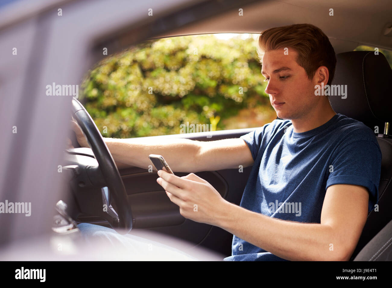 Reading whilst driving hi-res stock photography and images - Alamy