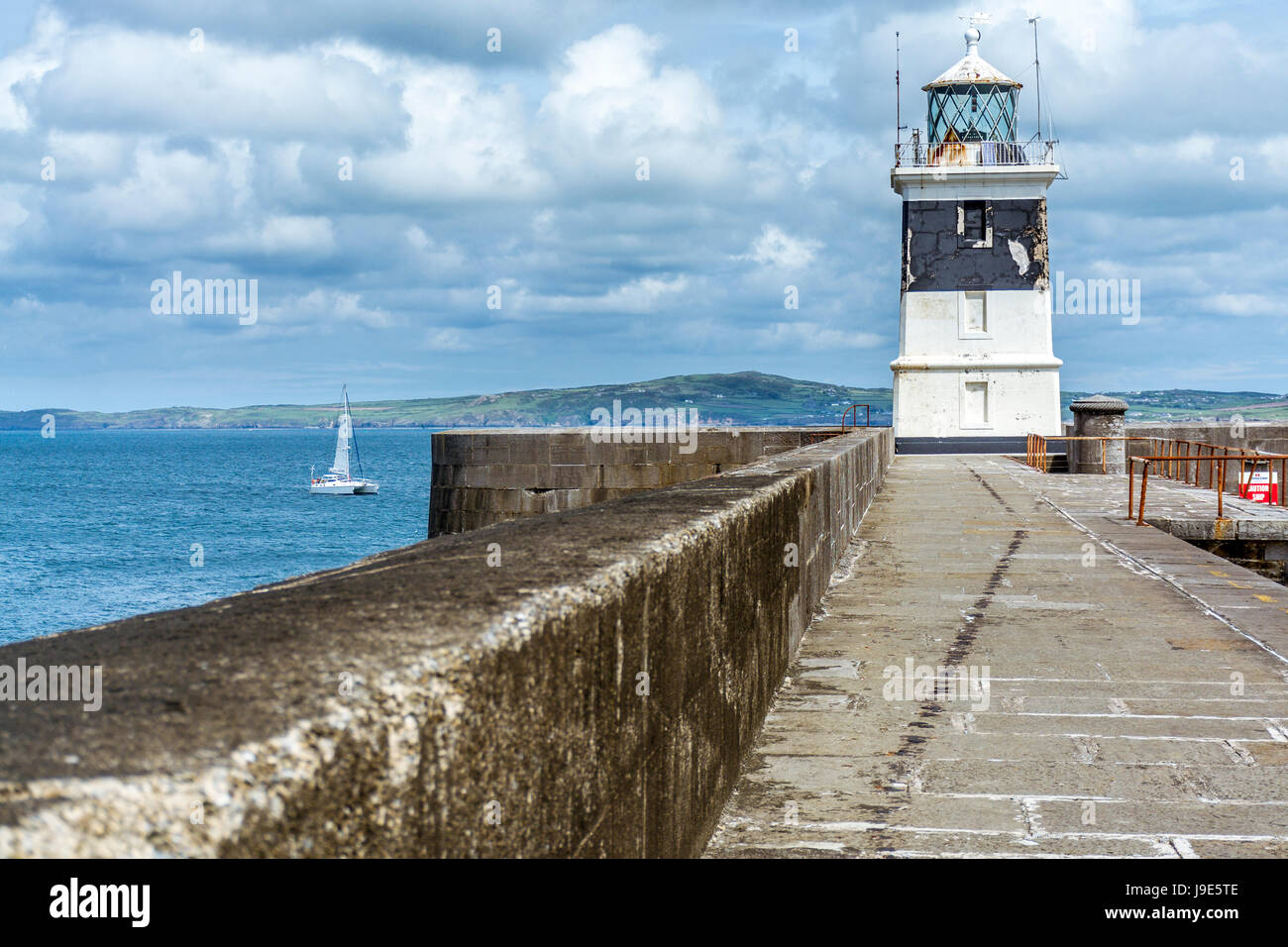 View of the lighthouse at the end of Holyhead breakwater on Anglesey ...