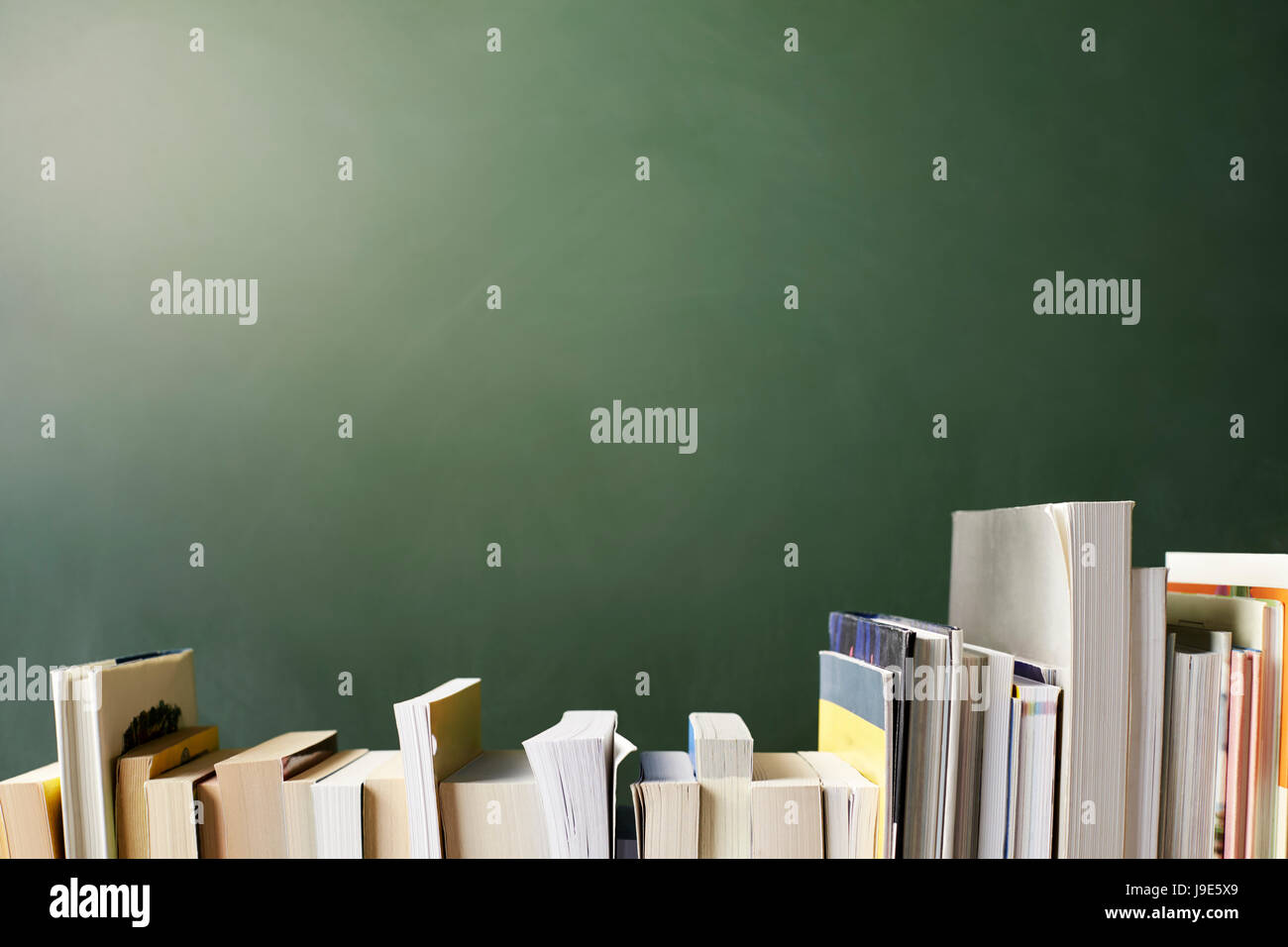 School chalkboard with books standing in the foreground Stock Photo - Alamy