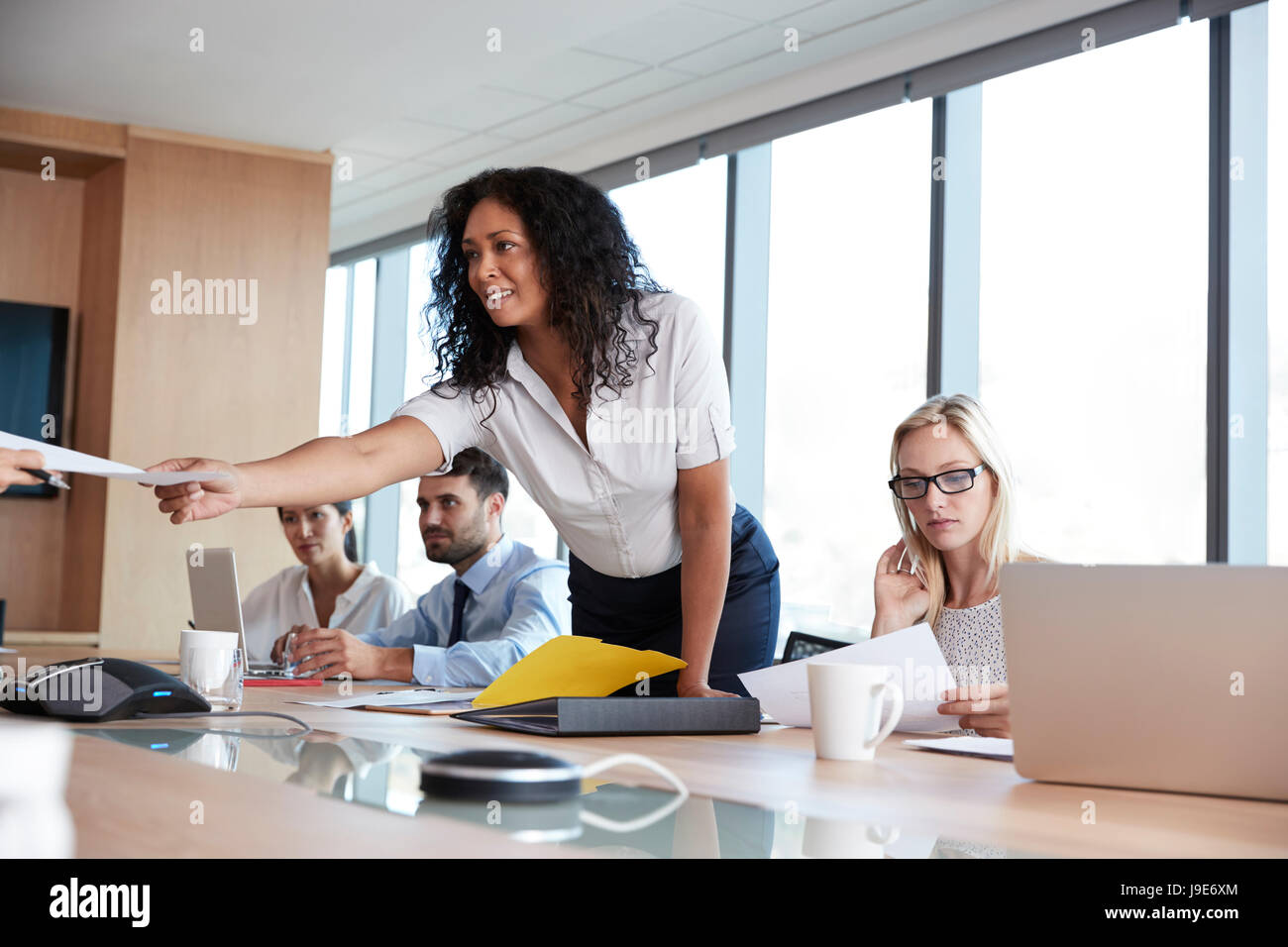 Businesswoman Stands To Address Meeting Around Board Table Stock Photo ...