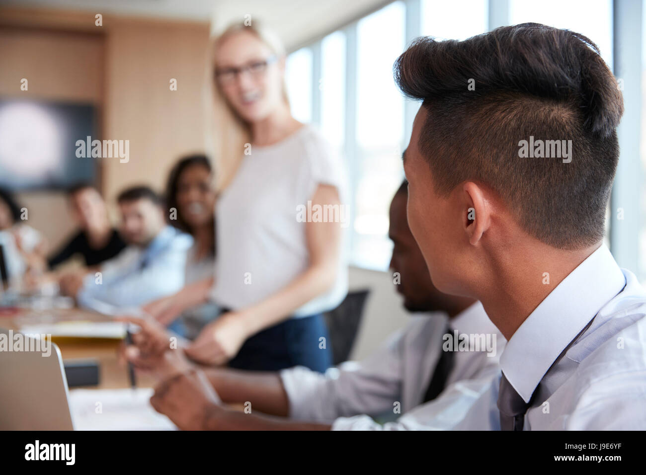 Businesswoman Stands To Address Meeting Around Board Table Stock Photo ...