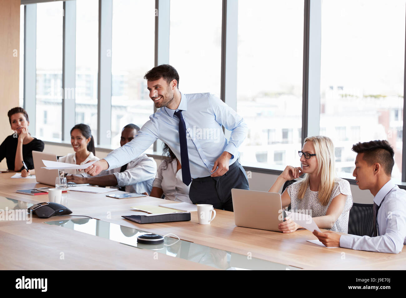 Businessman Stands To Address Meeting Around Board Table Stock Photo ...