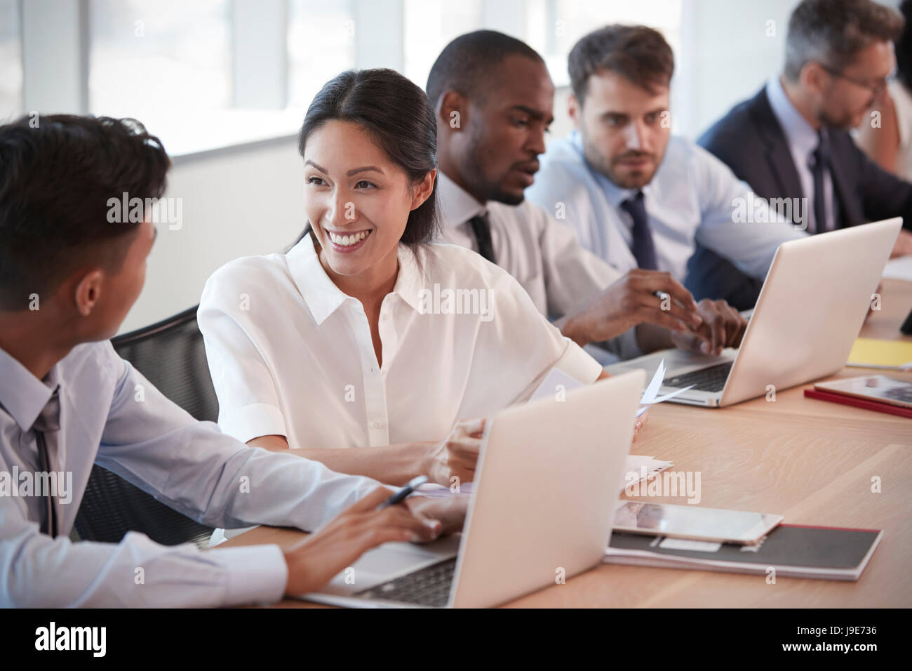Group Of Businesspeople Meeting Around Table In Boardroom Stock Photo ...