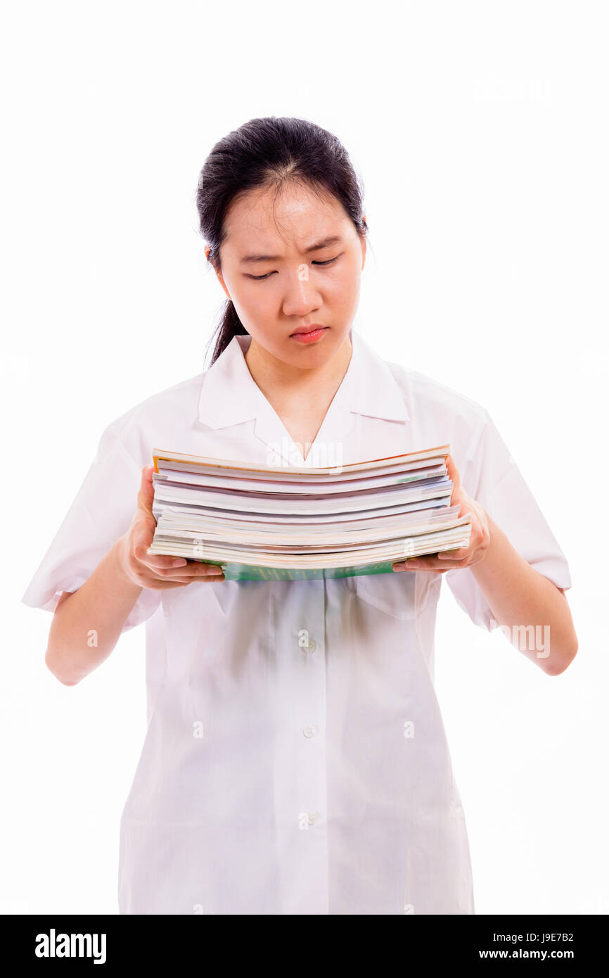Chinese high school girl in uniform holding a stack of books, looking ...