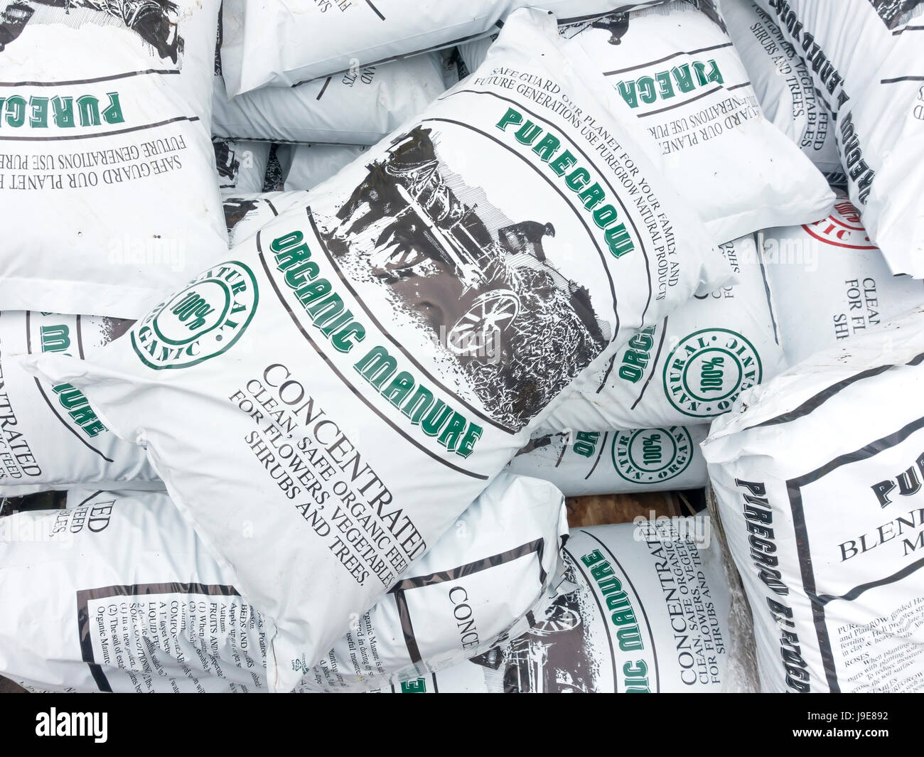 A stack of bags of Puregrow Organic Manure in a garden centre Stock ...