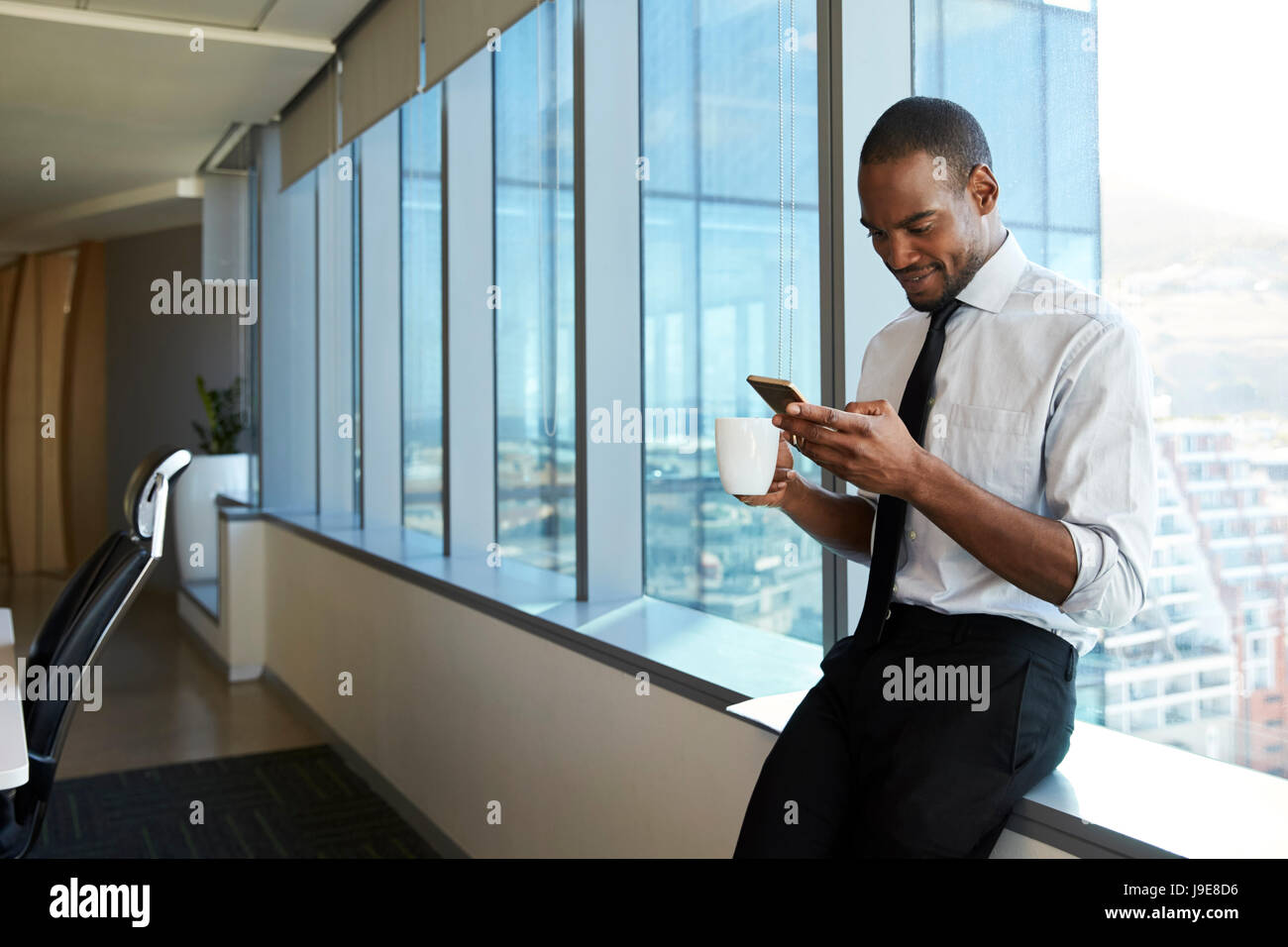 Businessman Checking Messages On Mobile Phone Stock Photo - Alamy