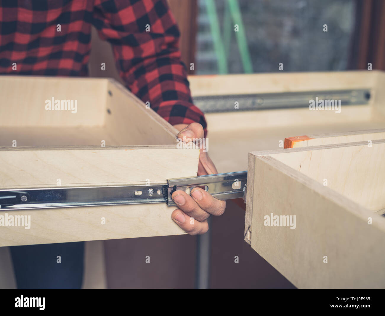A carpenter is building a drawer in his workshop Stock Photo - Alamy