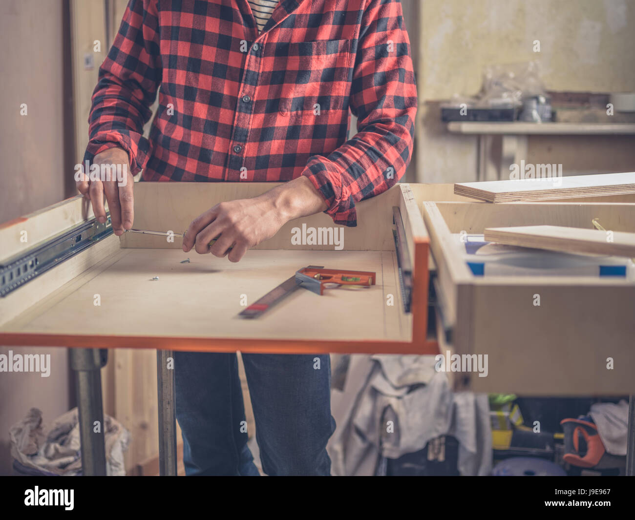 A carpenter is building a drawer in his workshop Stock Photo - Alamy