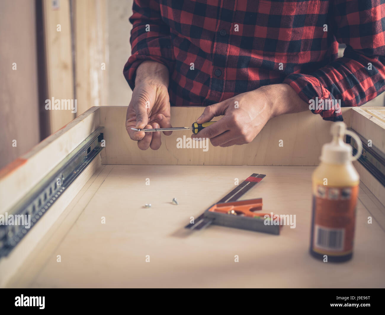 A carpenter is building a drawer in his workshop Stock Photo - Alamy
