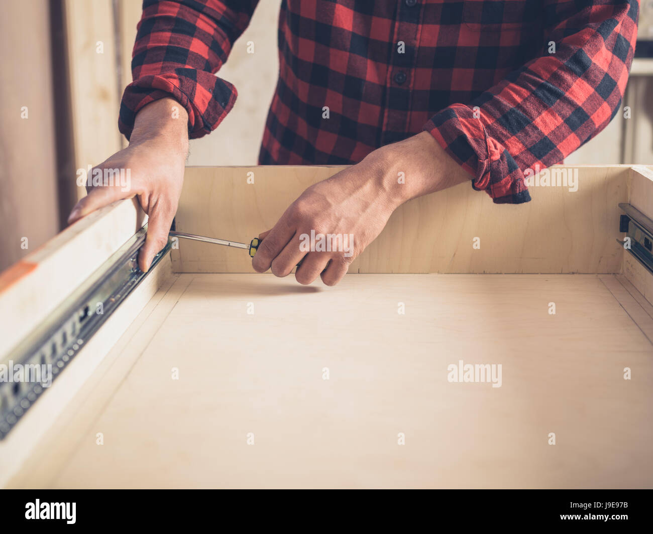 A carpenter is building a drawer in his workshop Stock Photo - Alamy