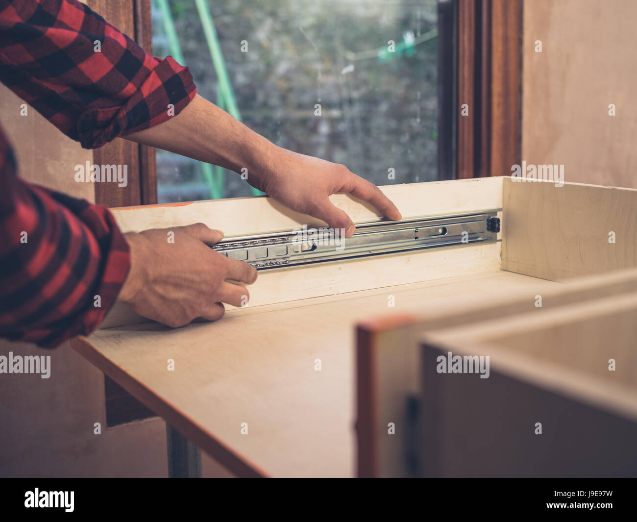 A carpenter is building a drawer in his workshop Stock Photo - Alamy
