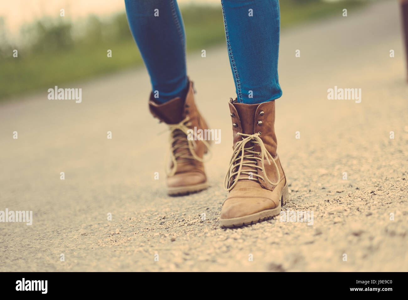 Traveler woman legs on the road Stock Photo - Alamy