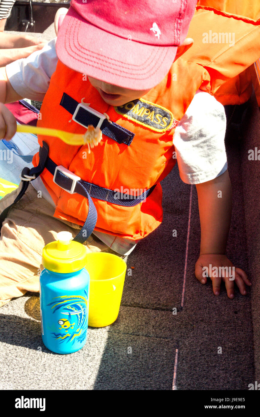 Boy eating in the boat Stock Photo - Alamy