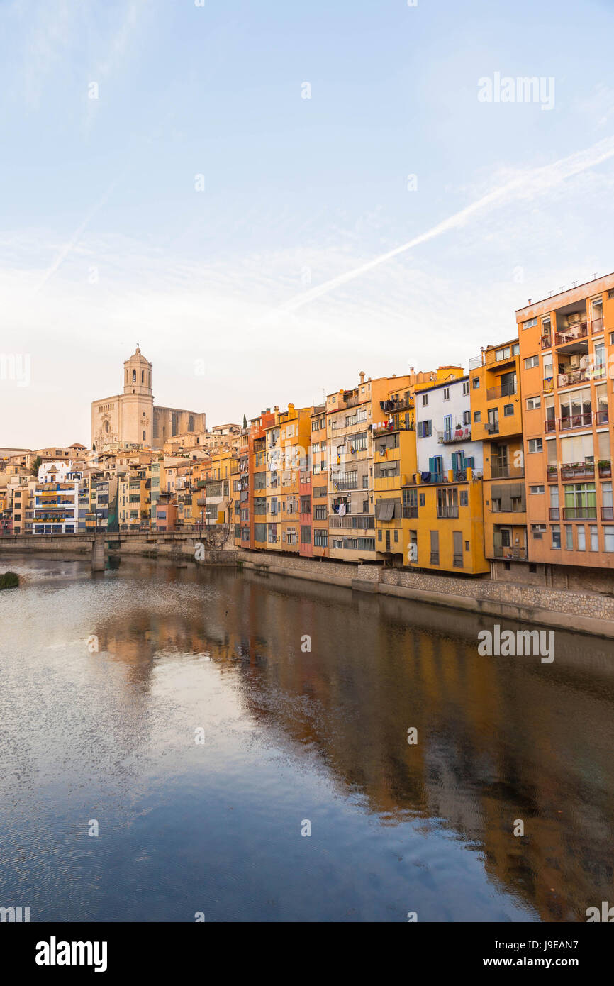 Onyar river crossing the downtown of Girona with bell tower of Basilica ...