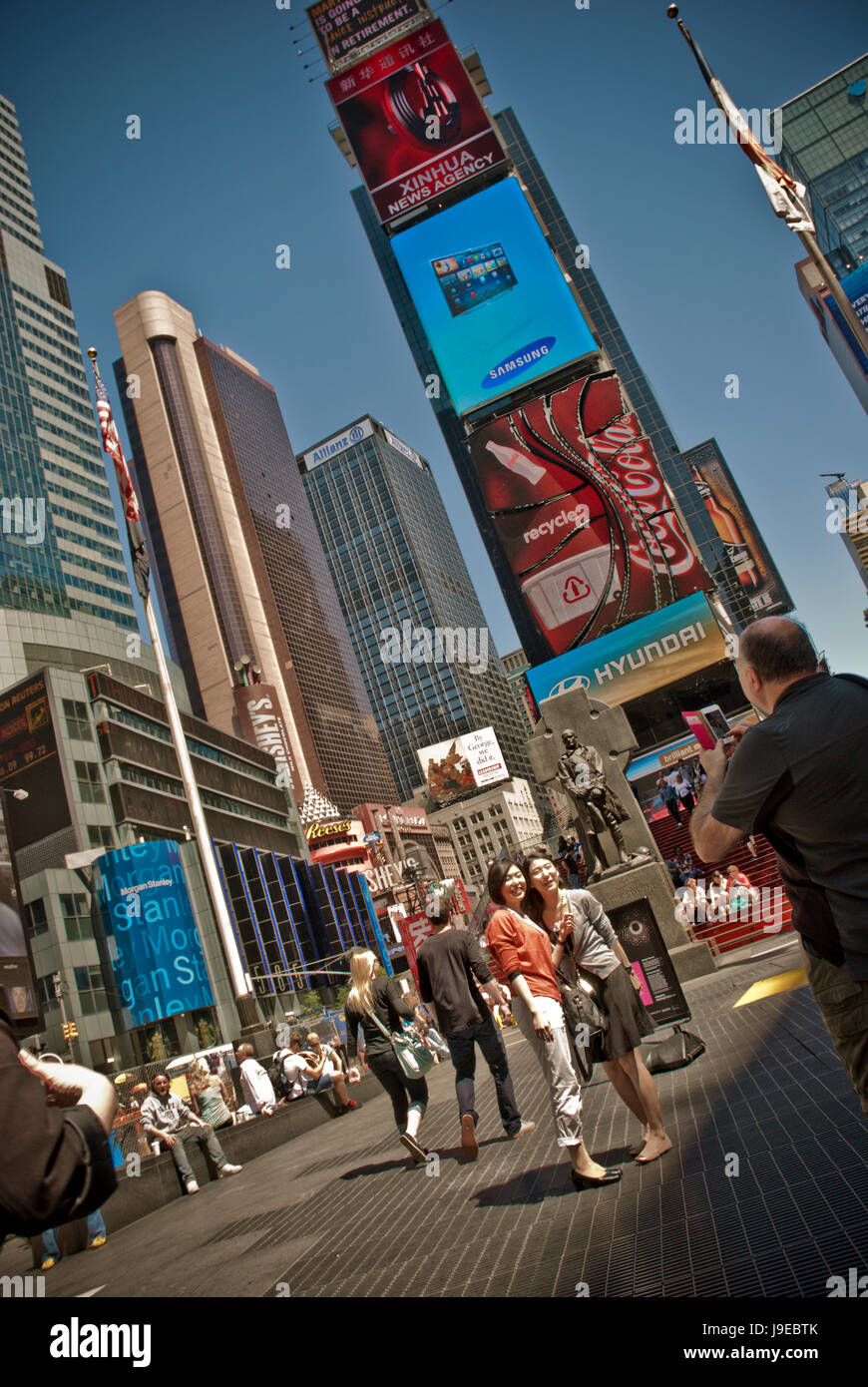 Man taking a picture of tourists on a smartphone on Times square, New ...